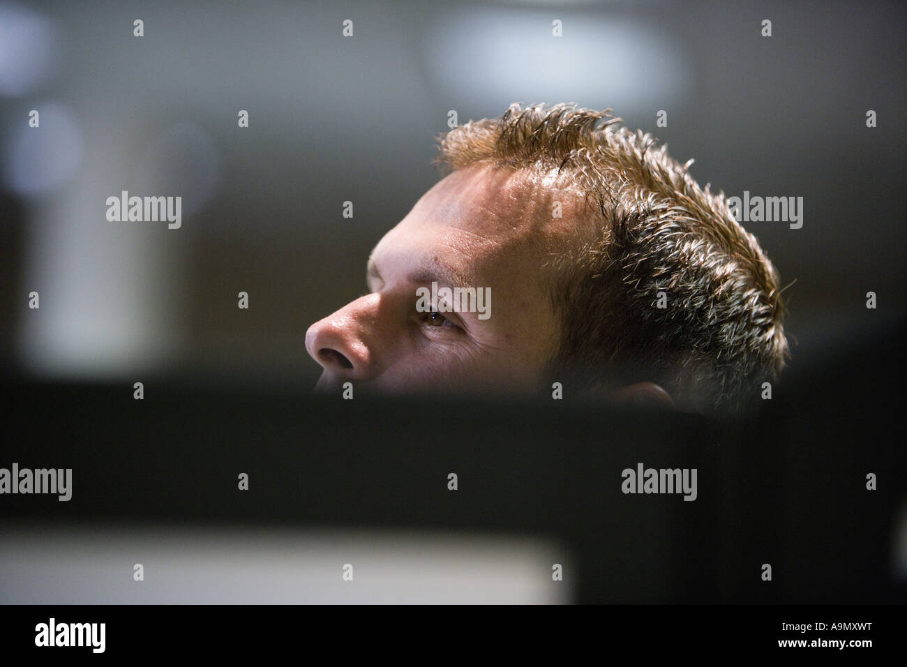 Close-up view of a man looking over a wall Stock Photo - Alamy