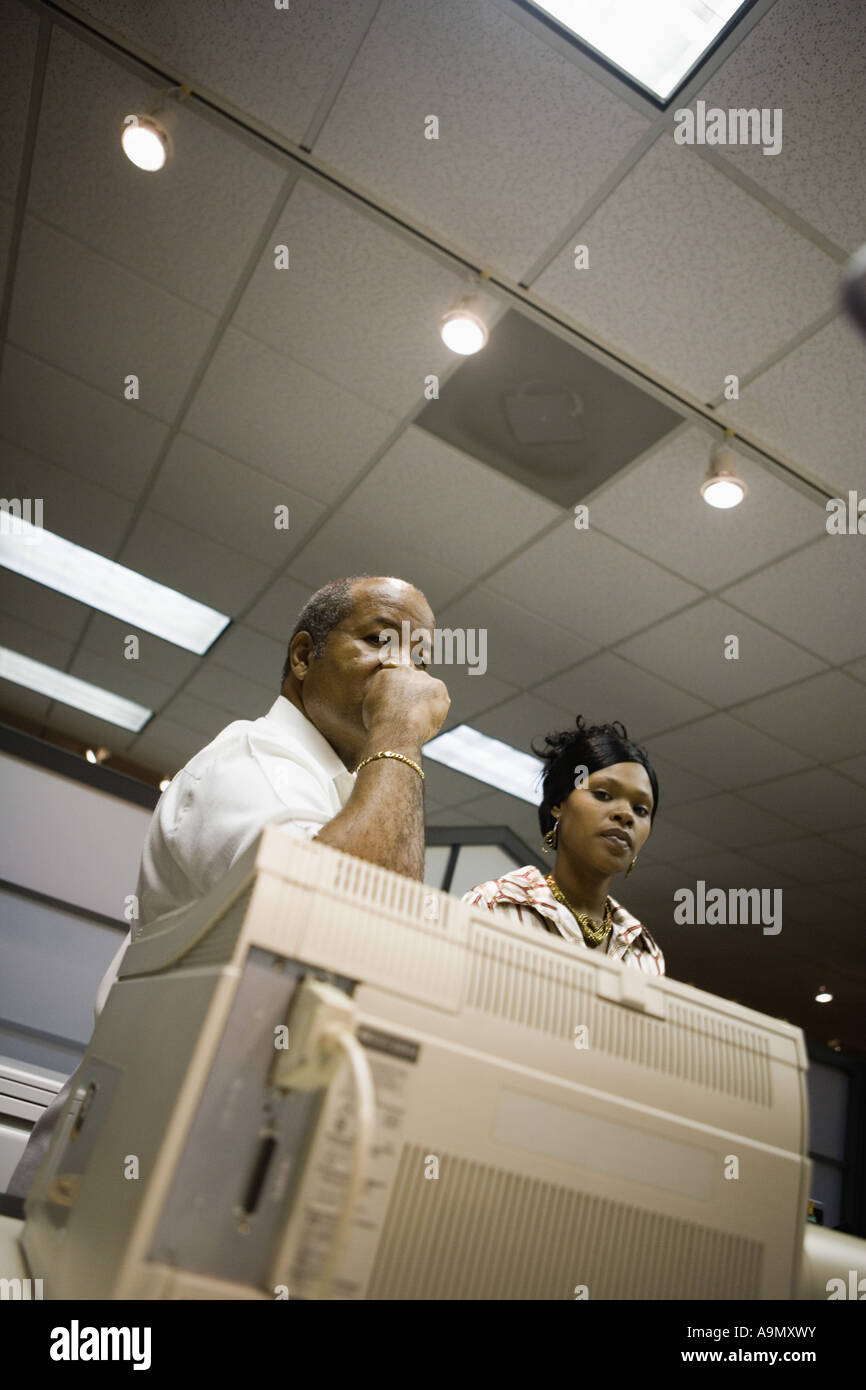 Business people standing next to copier Stock Photo - Alamy