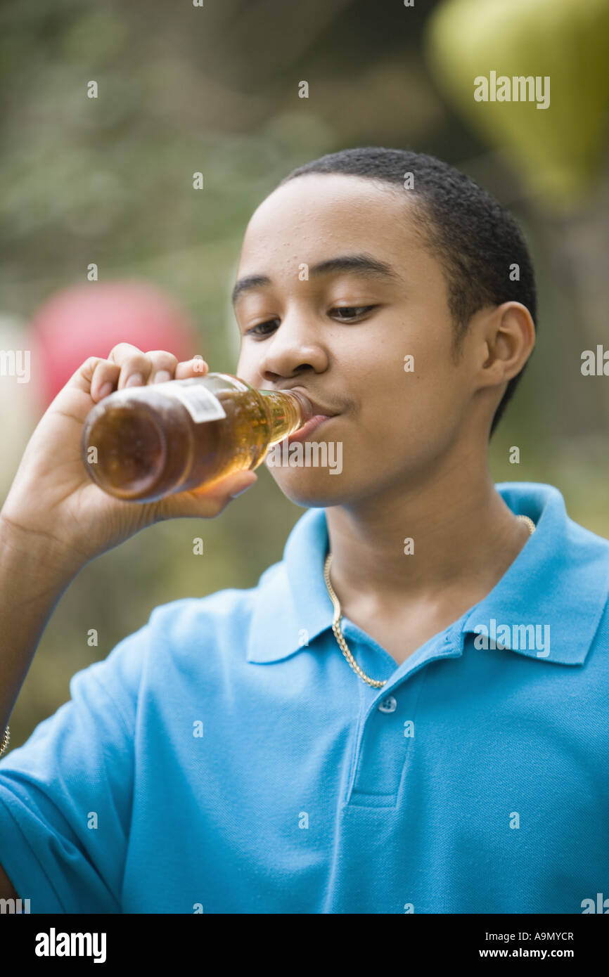 Boy drinking bottle of soda Stock Photo - Alamy