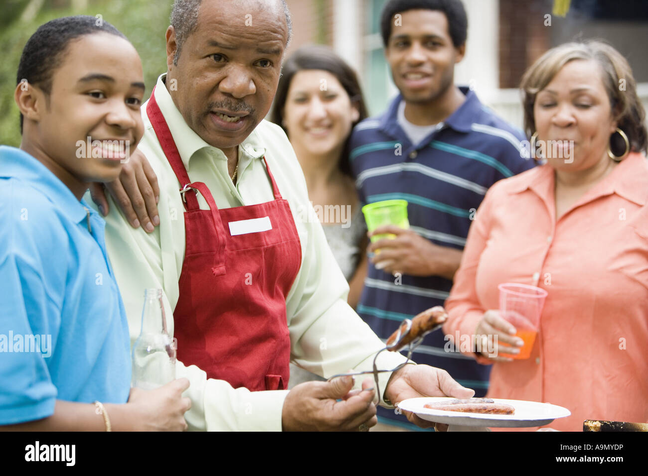 Family and friends at backyard cookout Stock Photo - Alamy