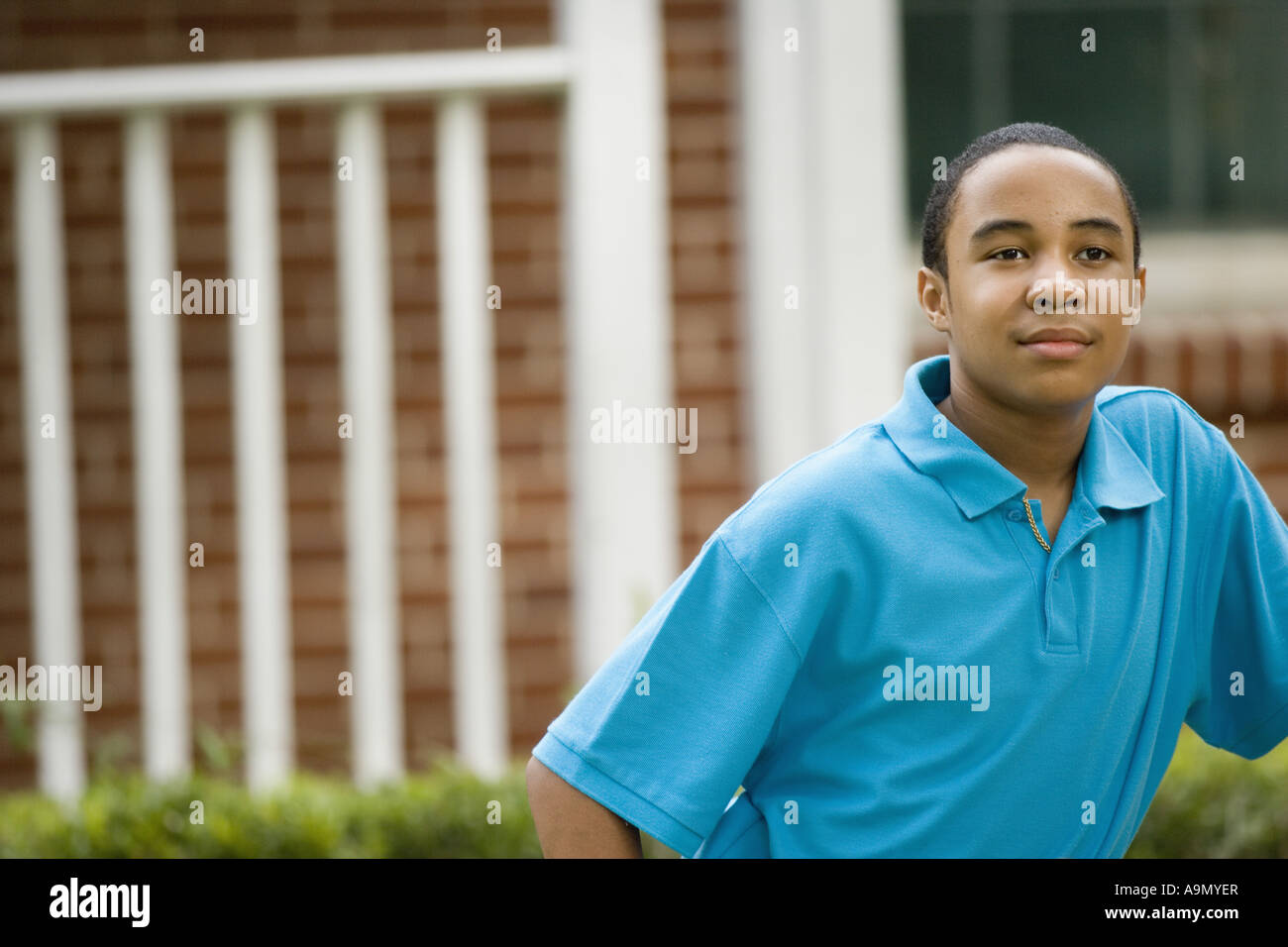 Portrait of teenage boy smiling in front of house Stock Photo - Alamy