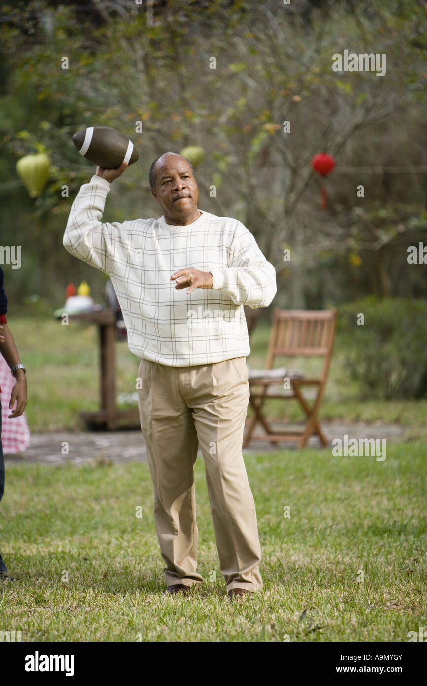 A mature man throwing a football Stock Photo - Alamy