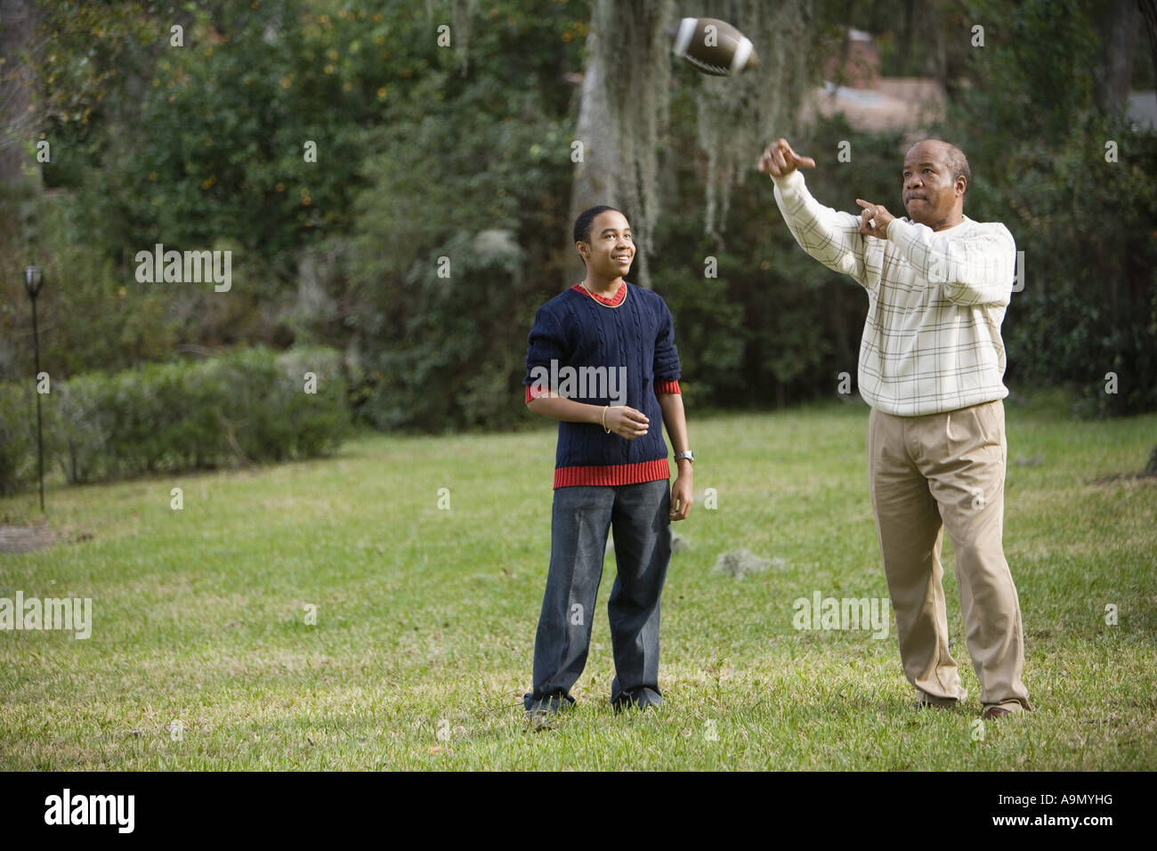 Father throwing football child hi-res stock photography and images - Alamy