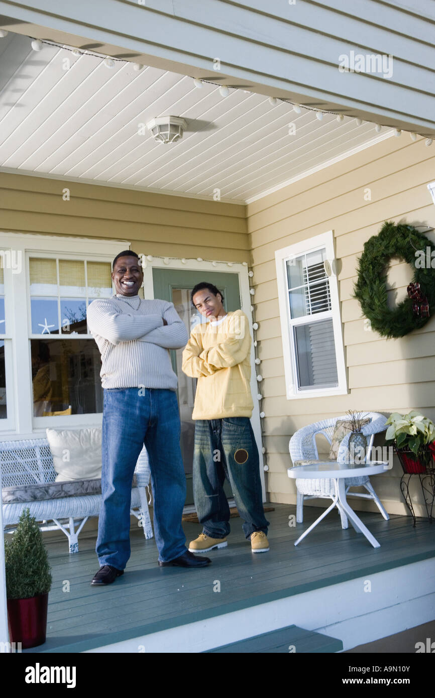 Portrait of father and son standing on porch Stock Photo - Alamy