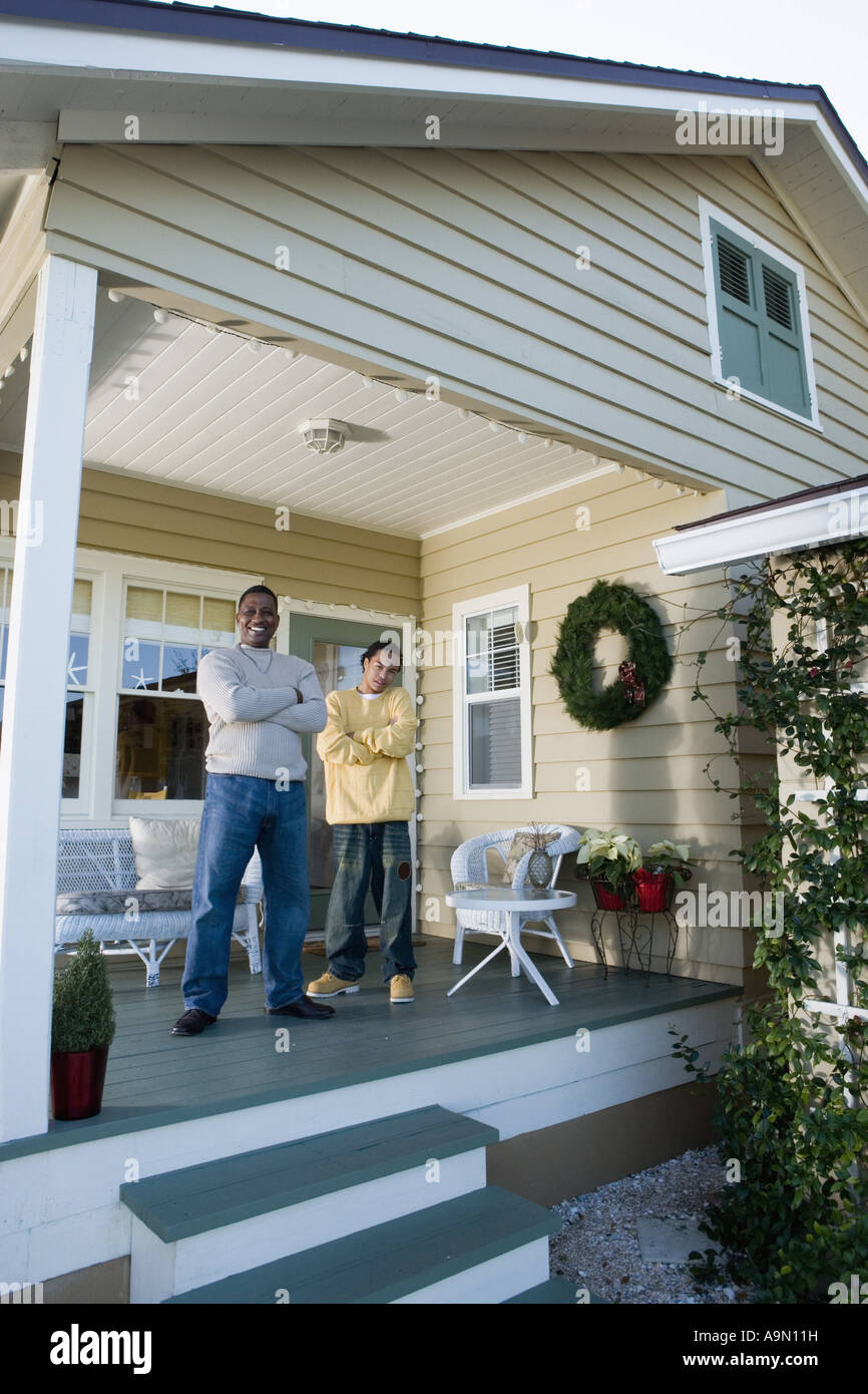 Portrait of father and son standing on porch Stock Photo - Alamy