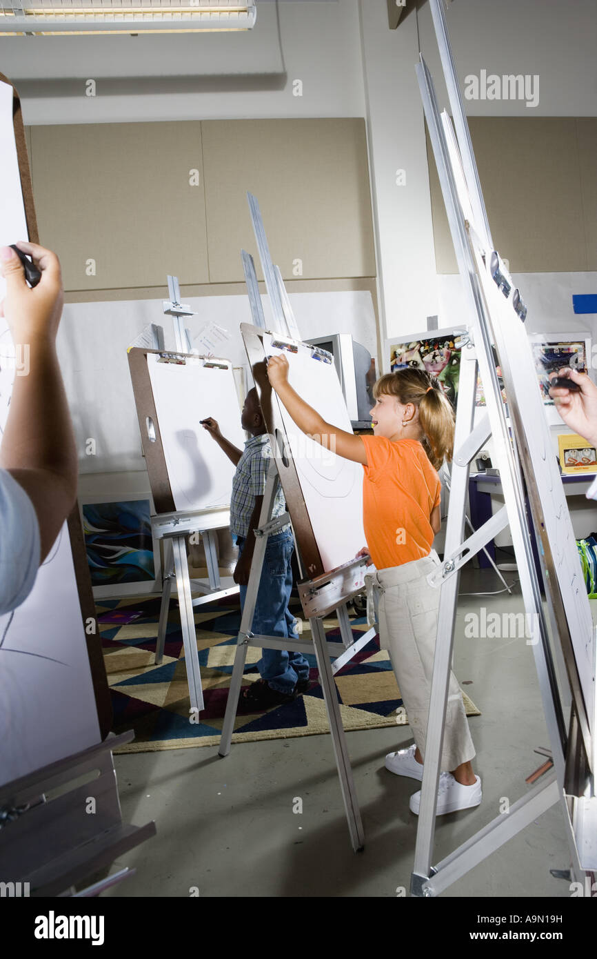 Students drawing on easels in art class Stock Photo - Alamy