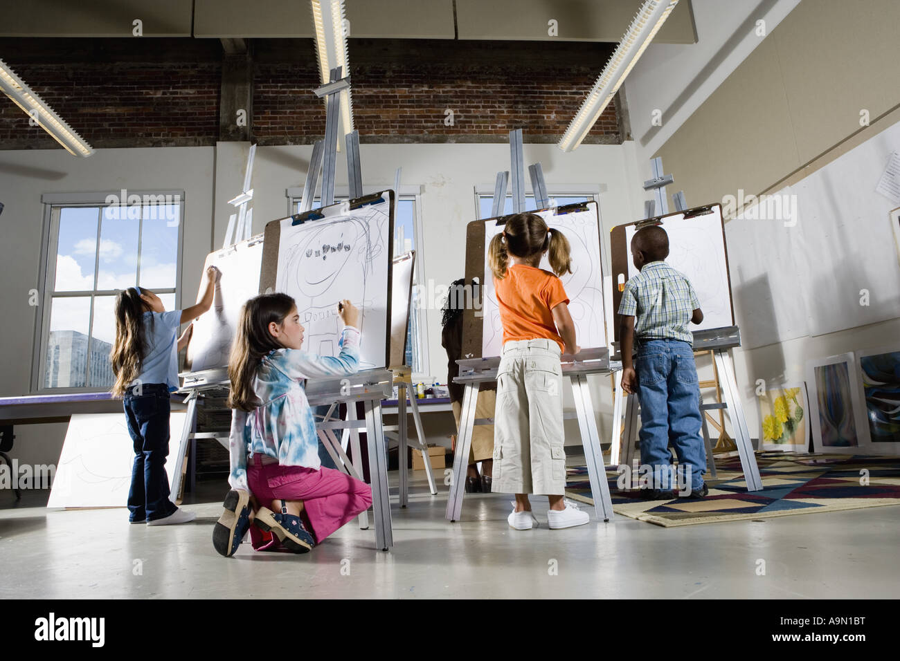 Children drawing on easels in art class Stock Photo - Alamy
