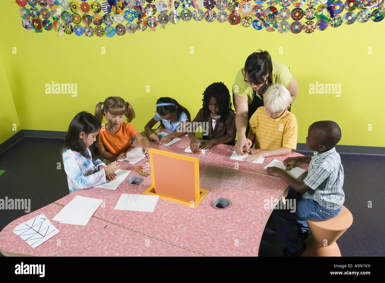 An art teacher observing her students drawing in art class Stock Photo ...