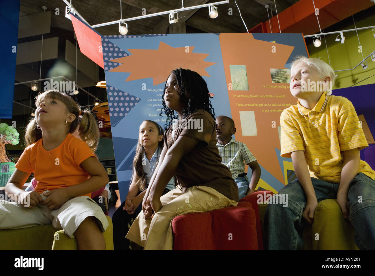 Boys and girls watching and listening attentively in a class Stock ...