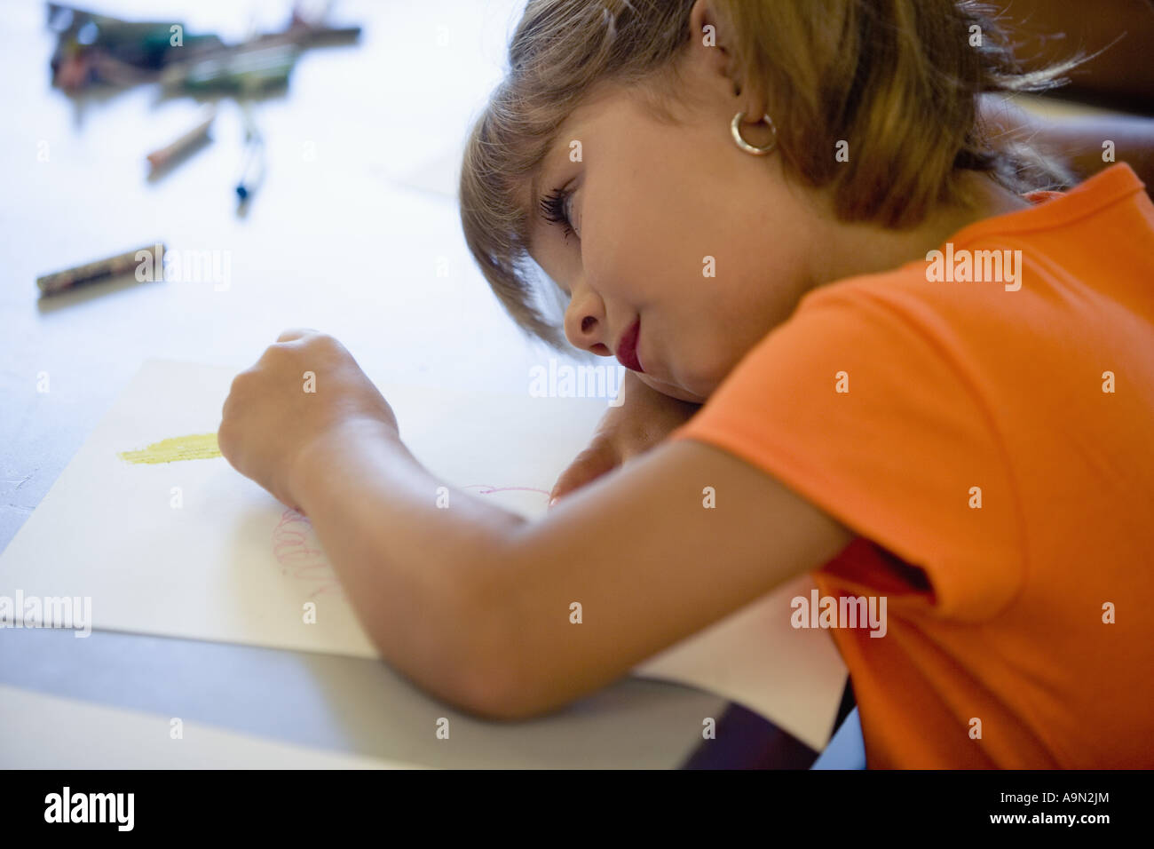 Girl drawing with crayons Stock Photo - Alamy