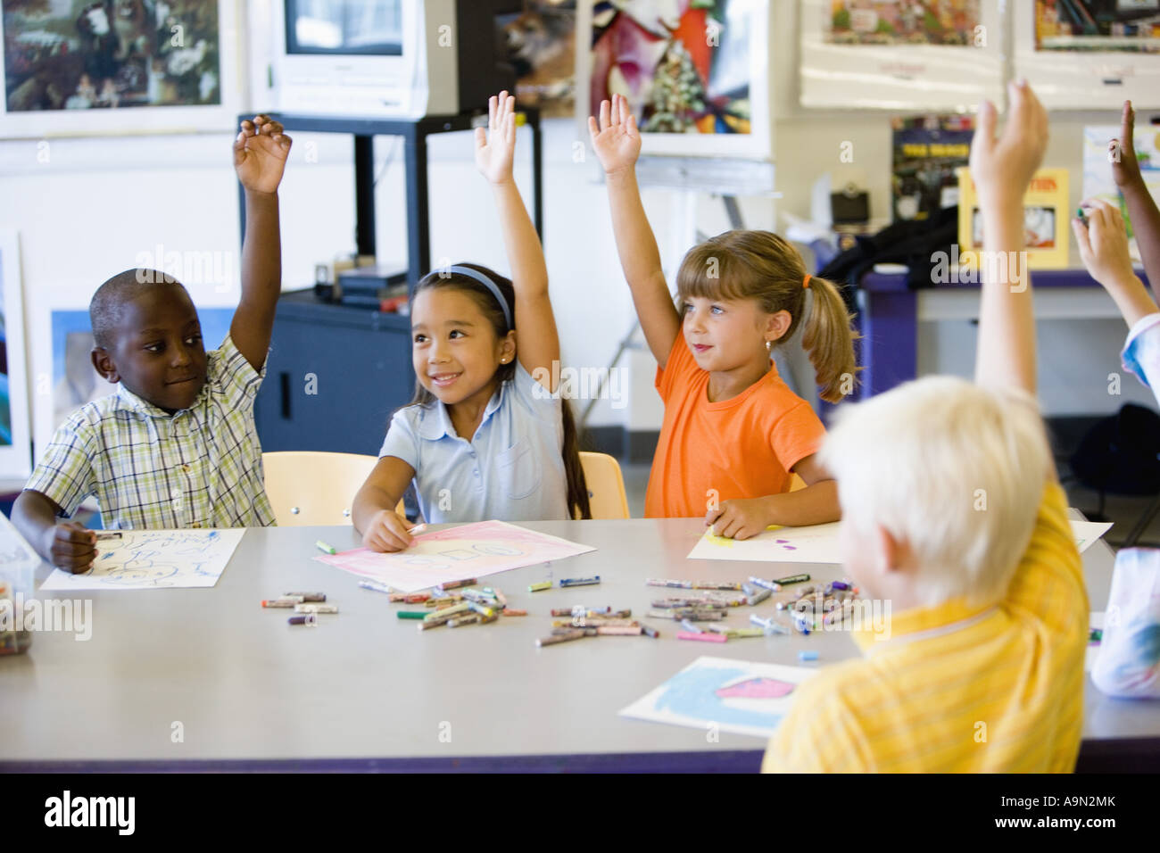 First graders raising hands hi-res stock photography and images - Alamy