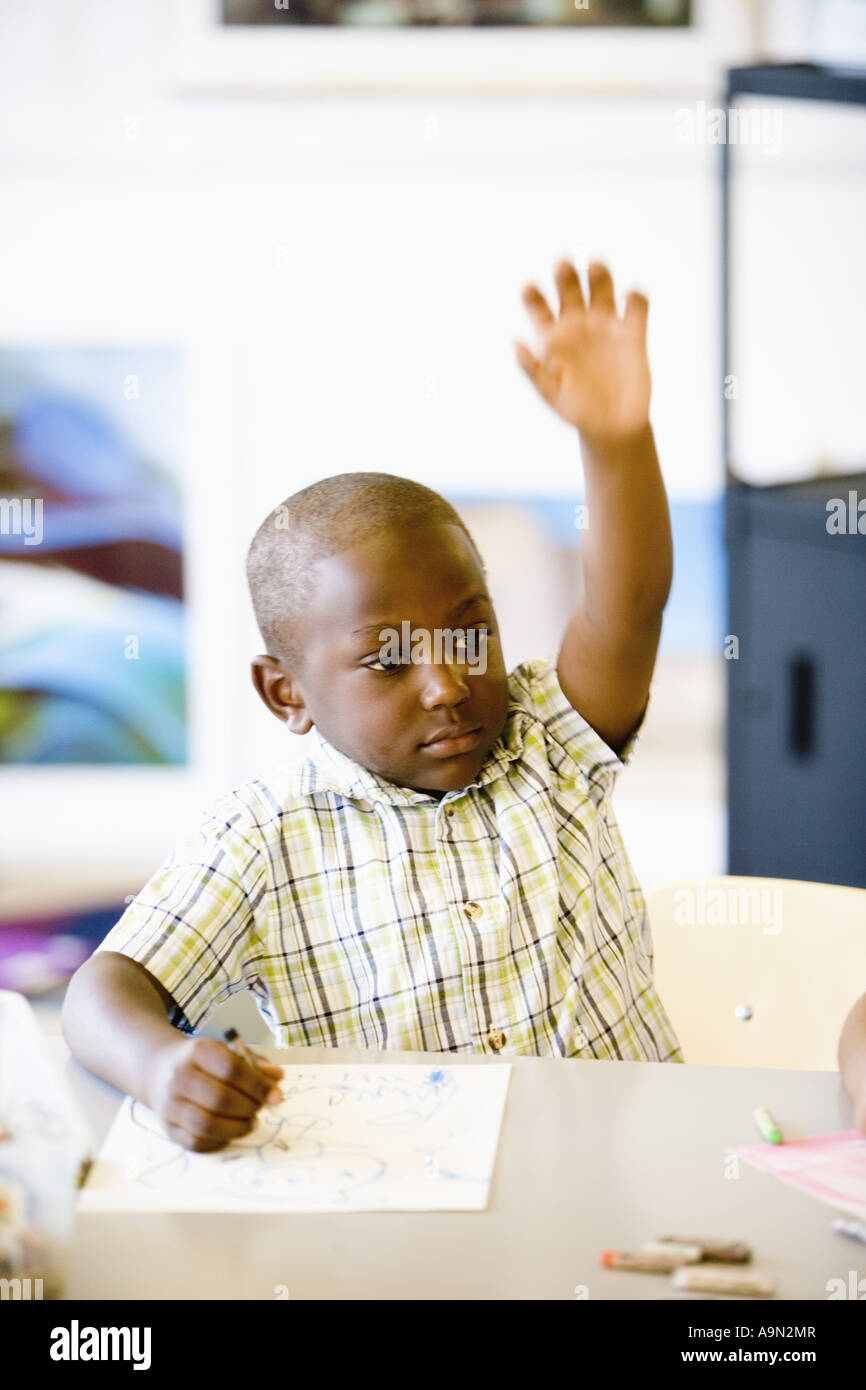 Close up of little boy raising his hand Stock Photo - Alamy