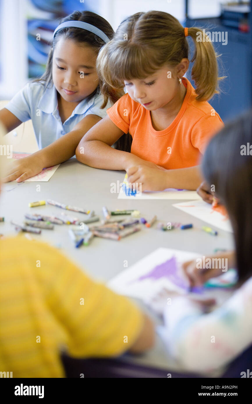 Girls drawing with crayons in an art class Stock Photo - Alamy