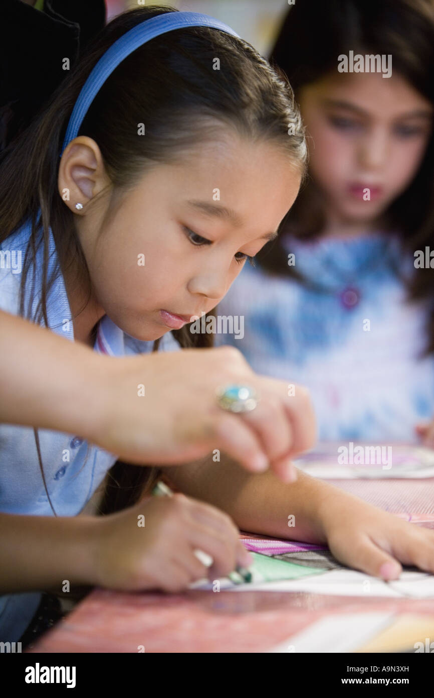 Girls drawing with color crayons Stock Photo - Alamy