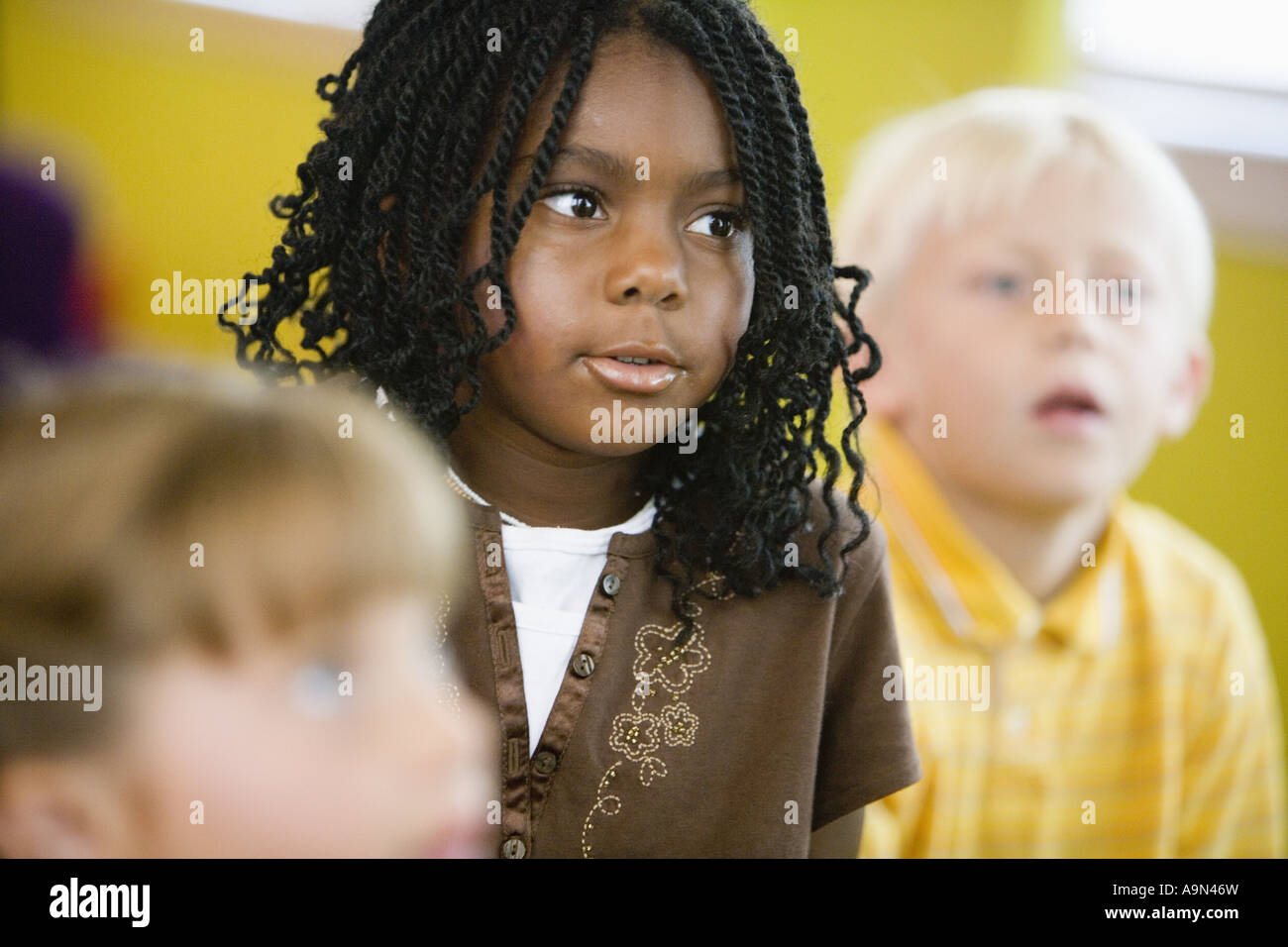 Young children watching and listening attentively Stock Photo - Alamy