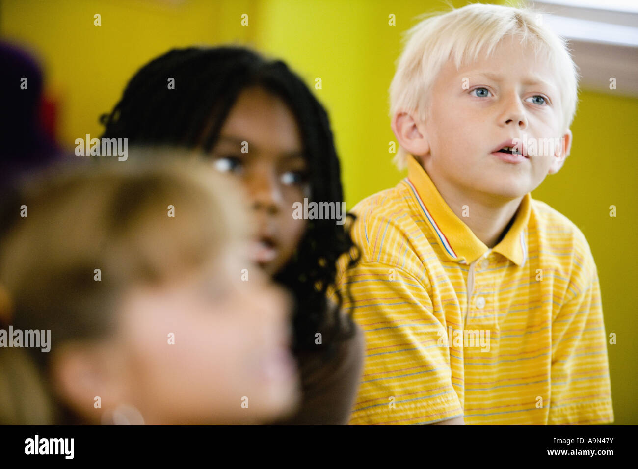 Young children watching and listening attentively Stock Photo - Alamy