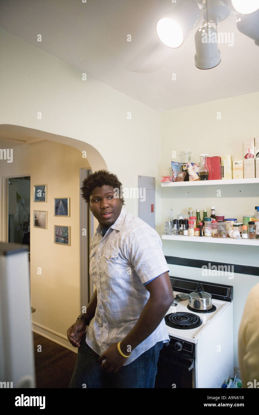 Young man standing in a kitchen Stock Photo - Alamy