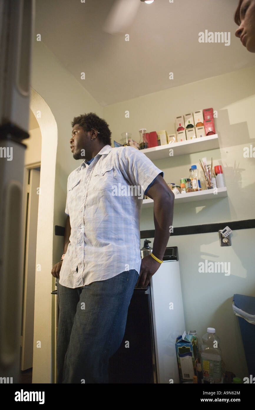 Young man standing in a kitchen Stock Photo - Alamy