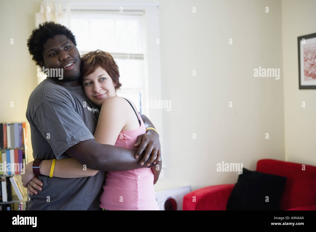 Young inter-racial couple embracing each other Stock Photo - Alamy