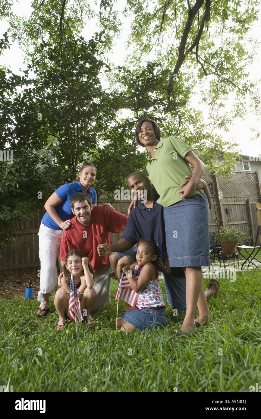 Portrait of two families standing together in backyard of house Stock ...