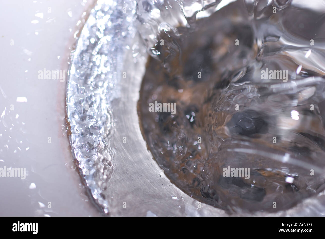 Water flowing down bathroom plughole plug hole Stock Photo - Alamy