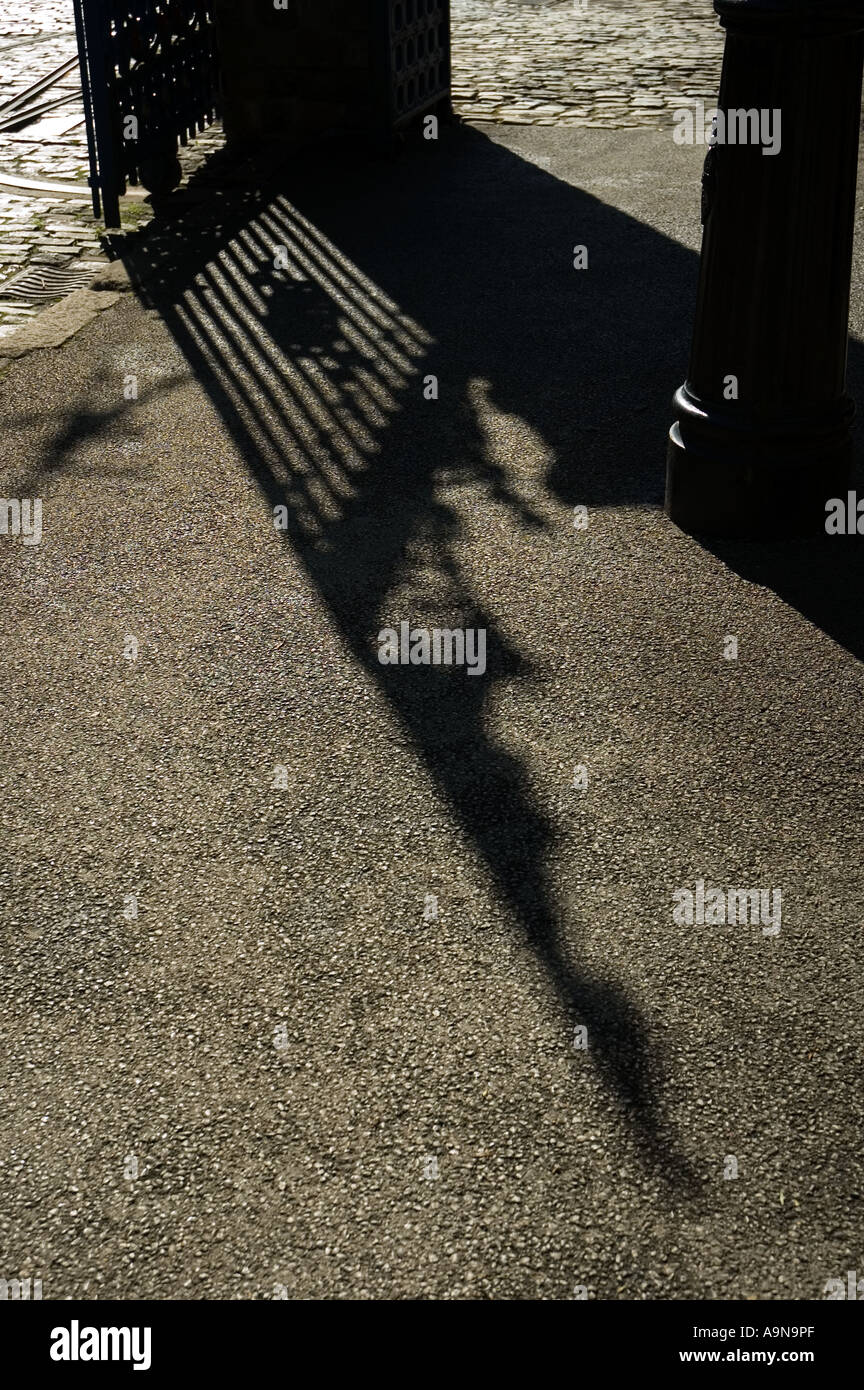 Shadow of a wrought iron gate, at the Crich Tramway Village, near ...