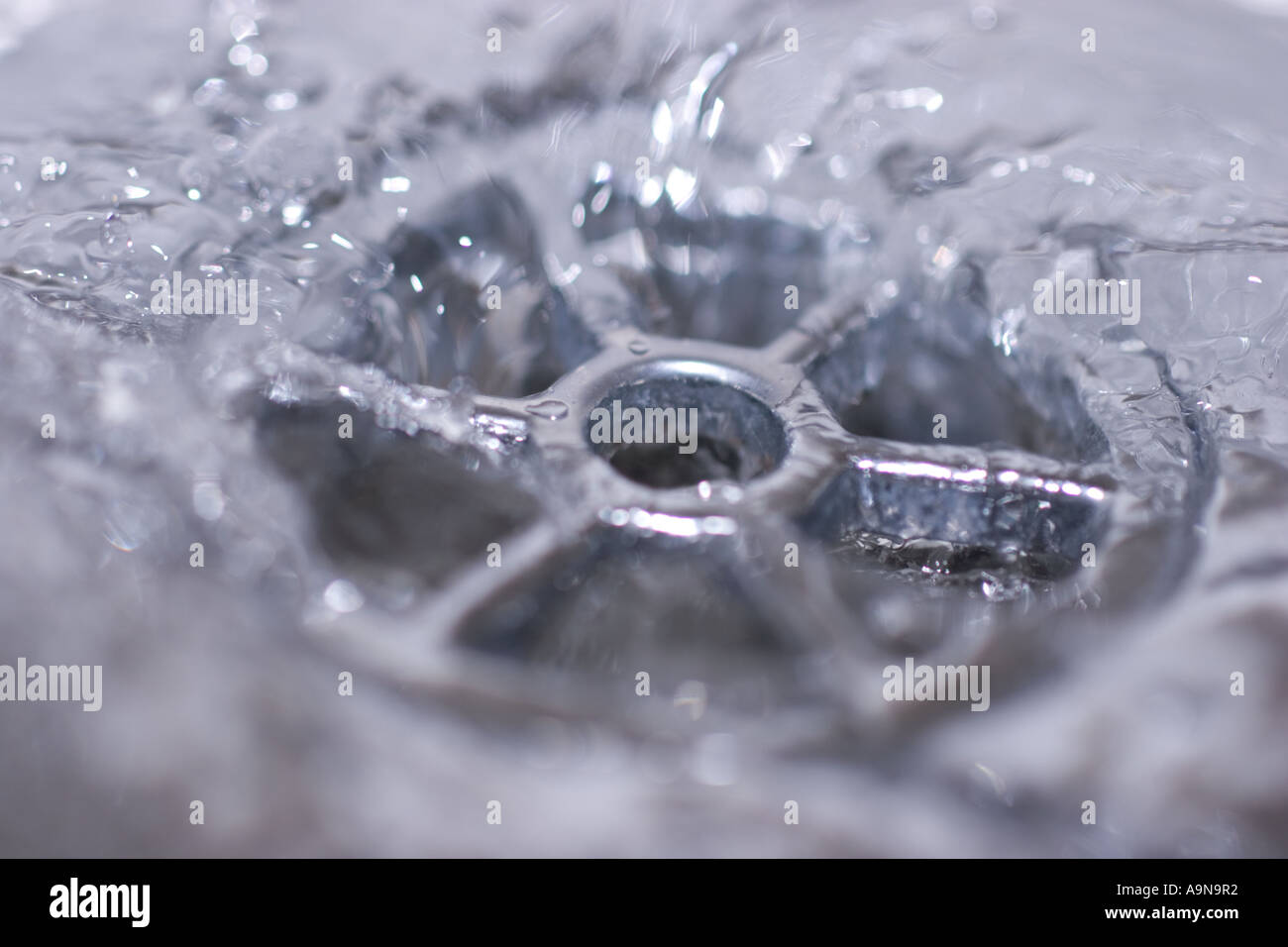Water flowing down bathroom plughole plug hole Stock Photo - Alamy