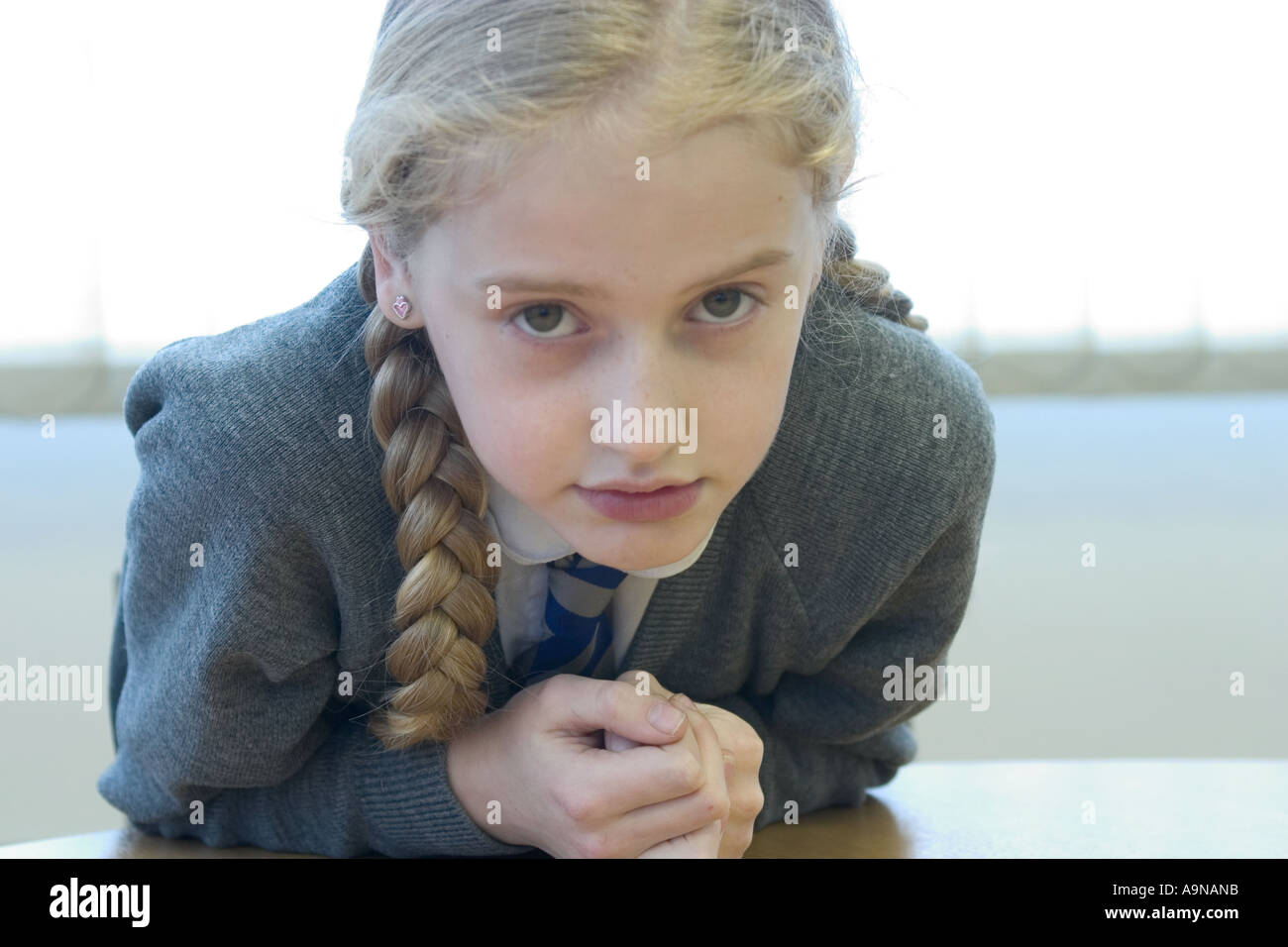 young schoolgirl leaning toward camera Stock Photo - Alamy