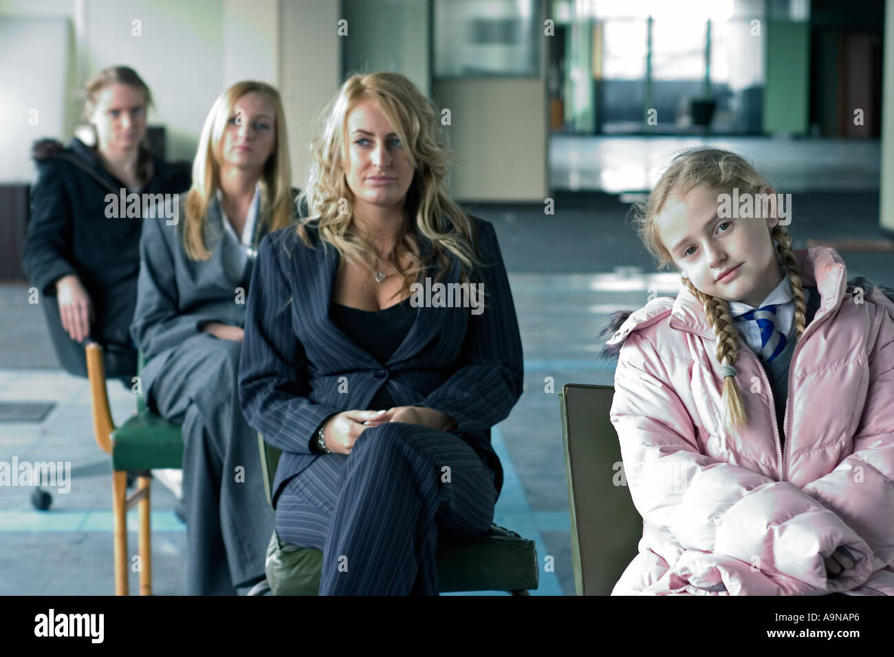 four sisters sitting in staggered line Stock Photo - Alamy