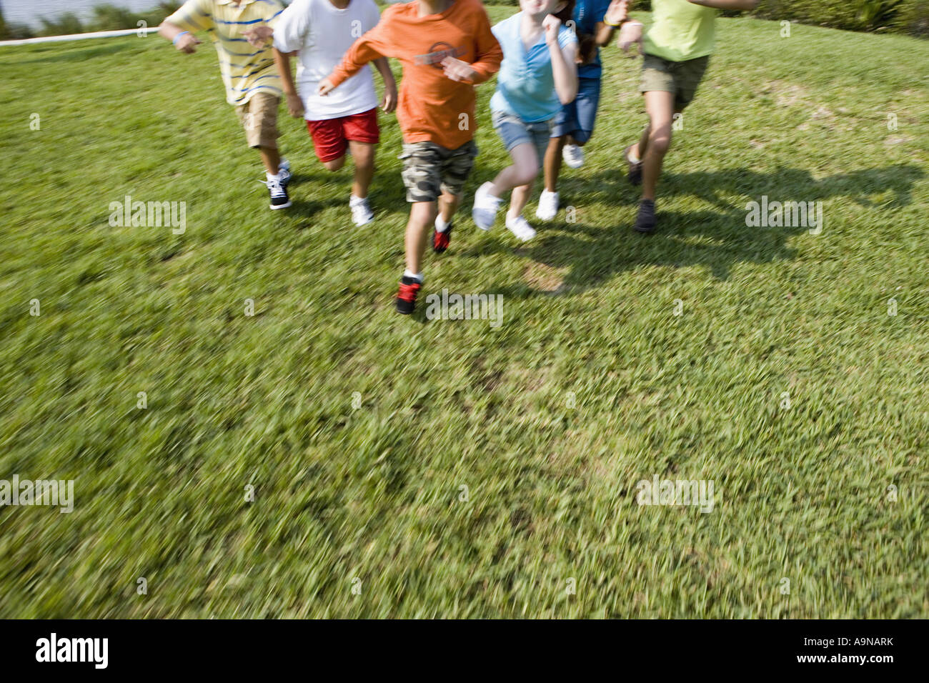 View of children's feet running towards the viewer Stock Photo - Alamy