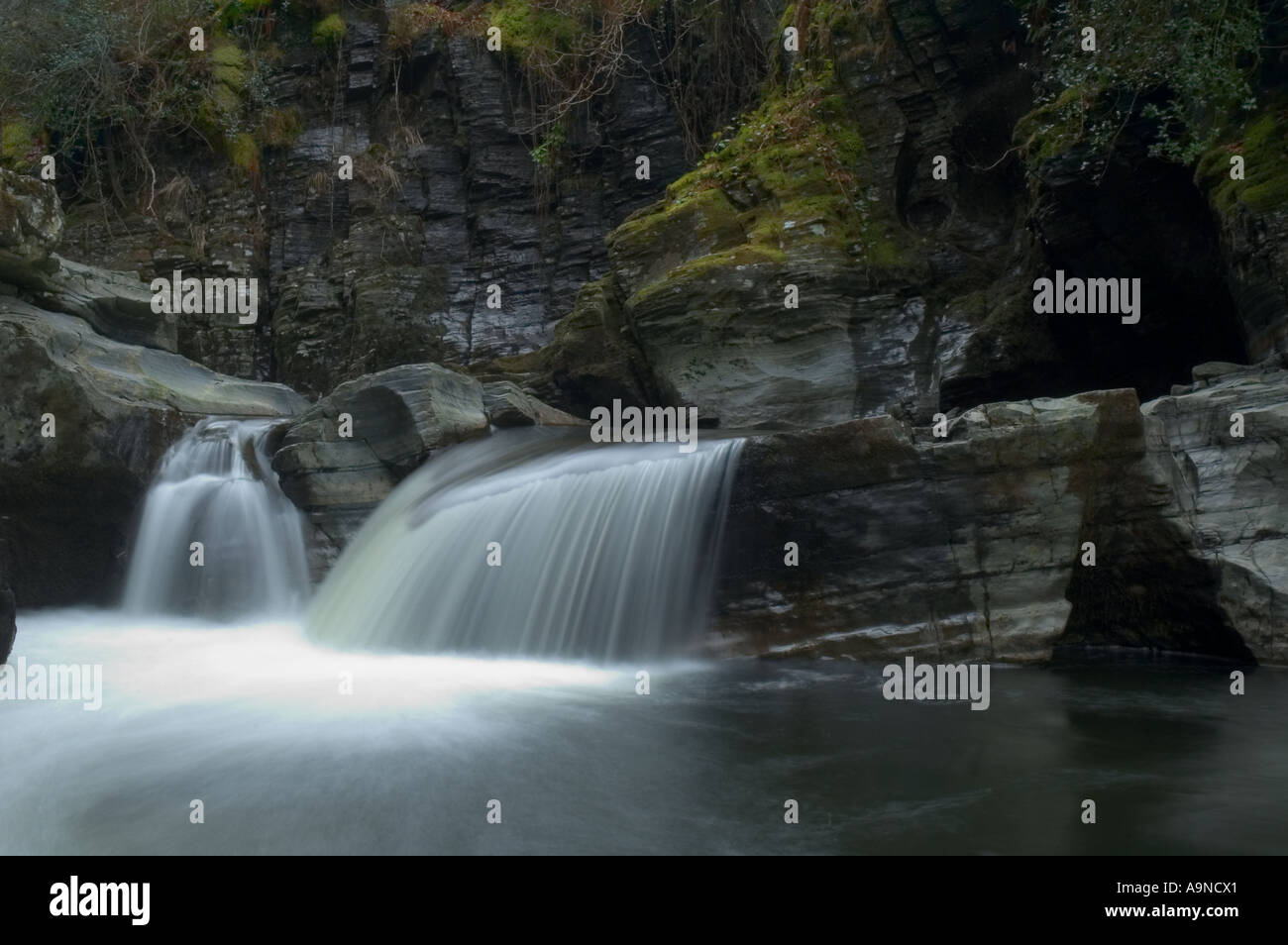 Landscape of river waterfall by cave and rocky cliff Stock Photo - Alamy