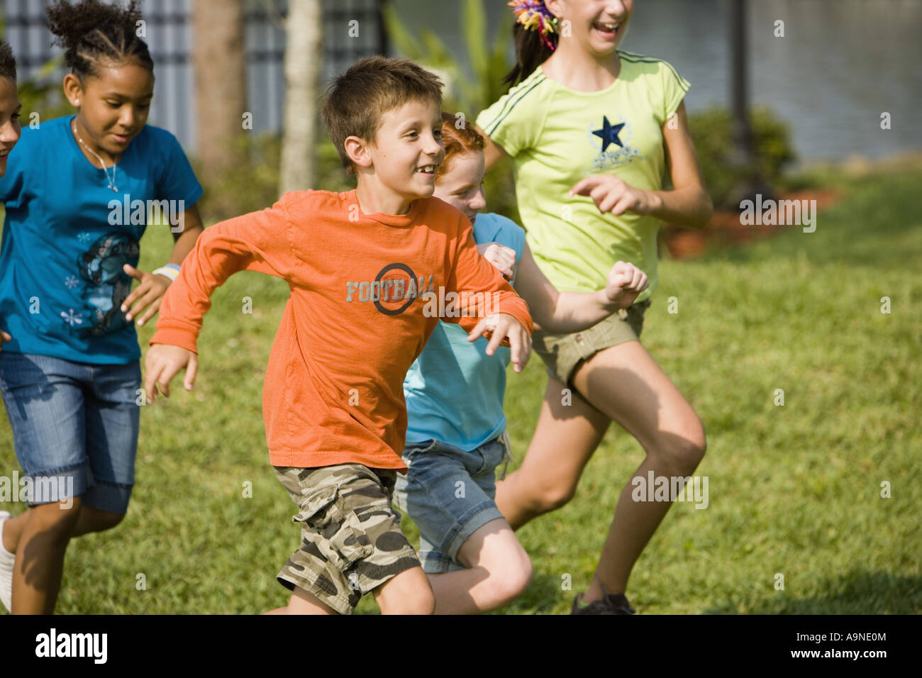Boys and girls running side by side at a park Stock Photo - Alamy