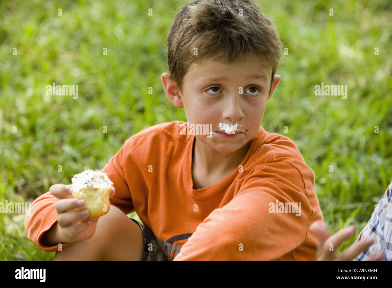Boy eating a cupcake hi-res stock photography and images - Alamy