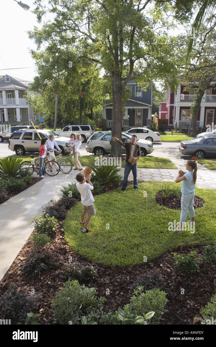 Father playing catch with children in front yard Stock Photo - Alamy