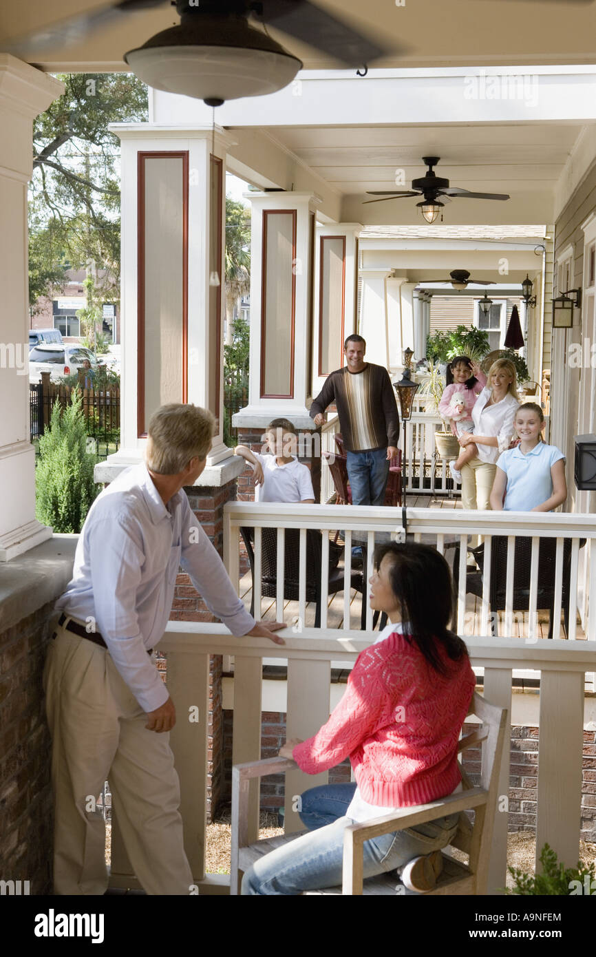 Next-door neighbors on front porches Stock Photo - Alamy