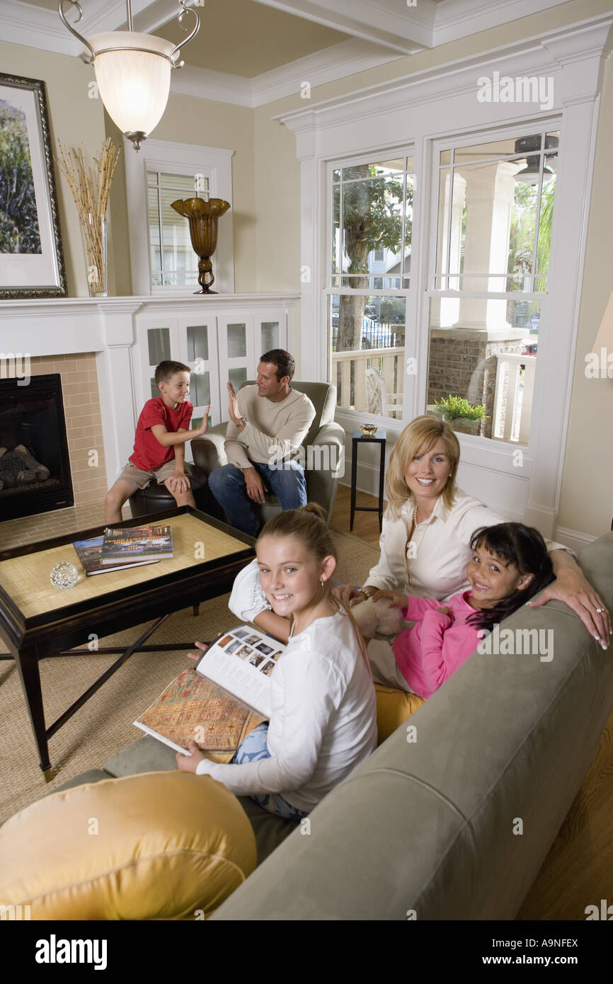 Family sitting together in the living room Stock Photo - Alamy