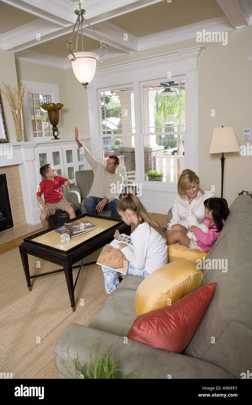 Family sitting together in the living room Stock Photo - Alamy