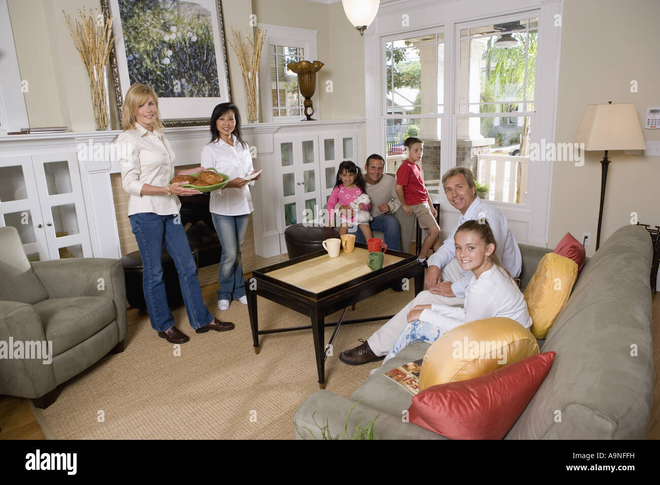 Family and friends together in living room Stock Photo - Alamy