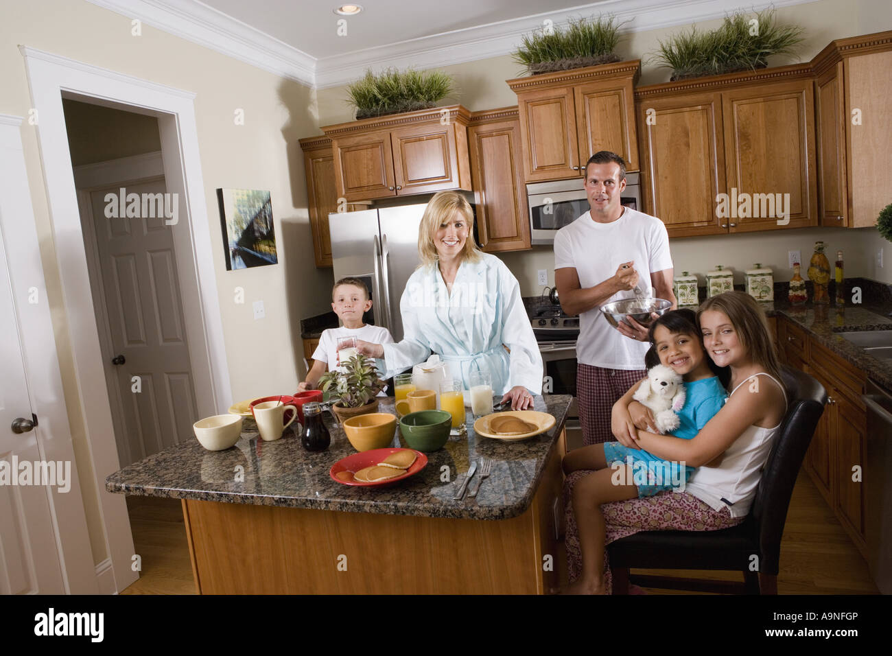 A family having breakfast in the kitchen Stock Photo - Alamy