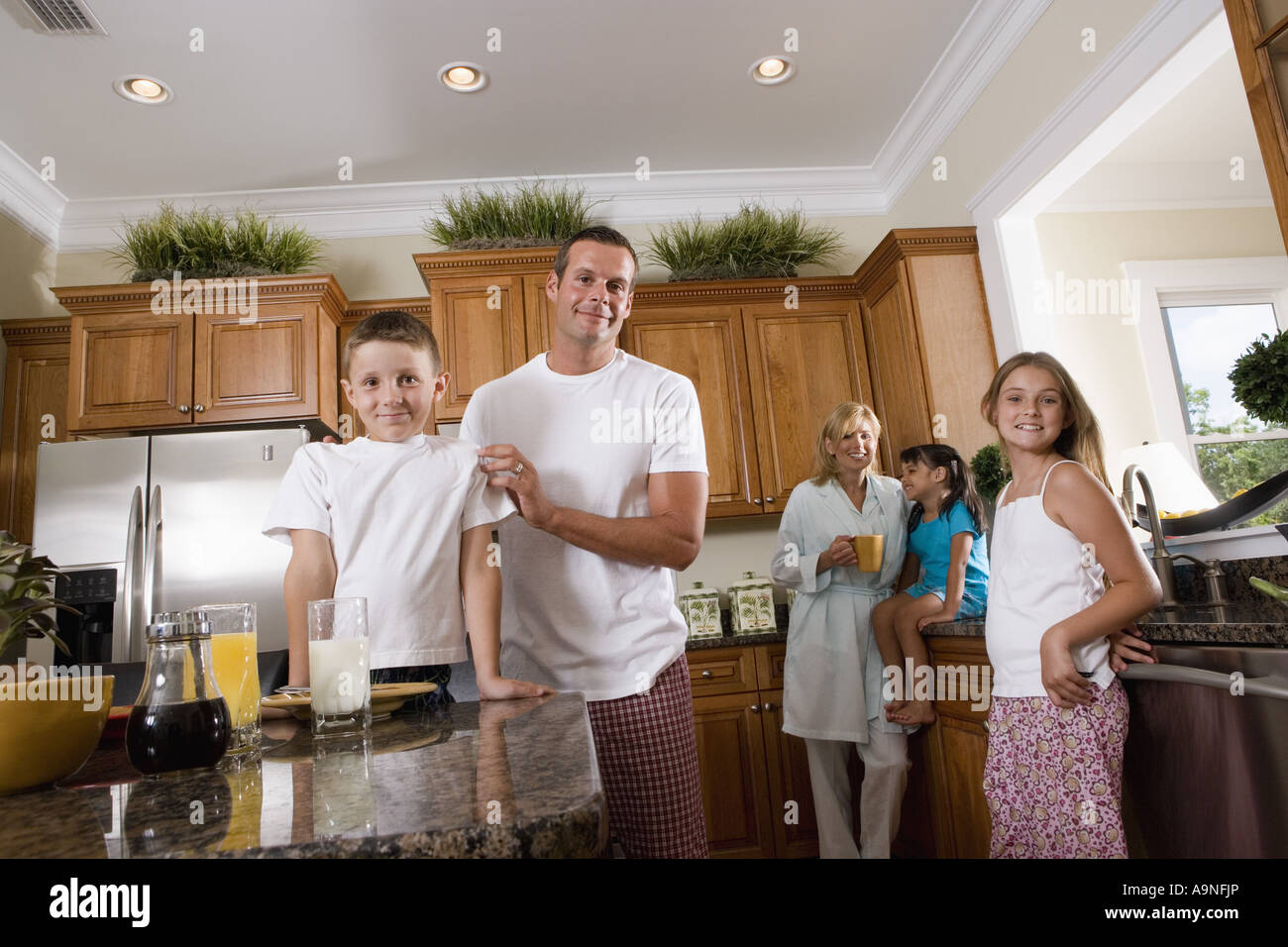 Family having breakfast in the kitchen Stock Photo - Alamy