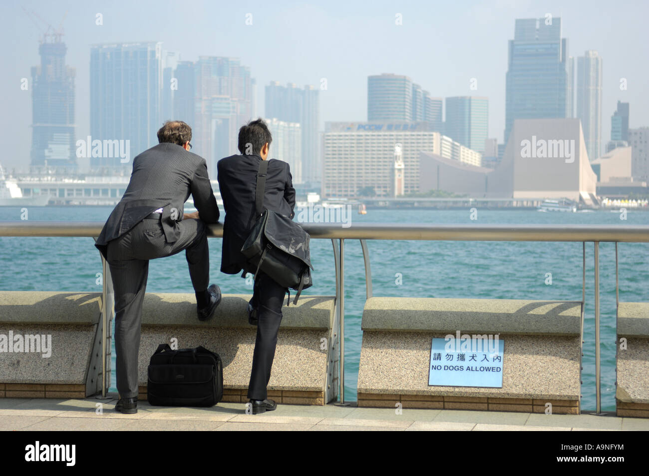 Two business men in front of Kowloon skyline, HongKong Stock Photo - Alamy