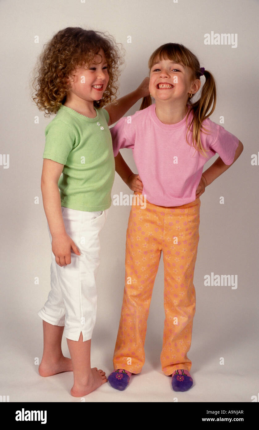 studio portrait 2 mischievous looking little girls Stock Photo - Alamy