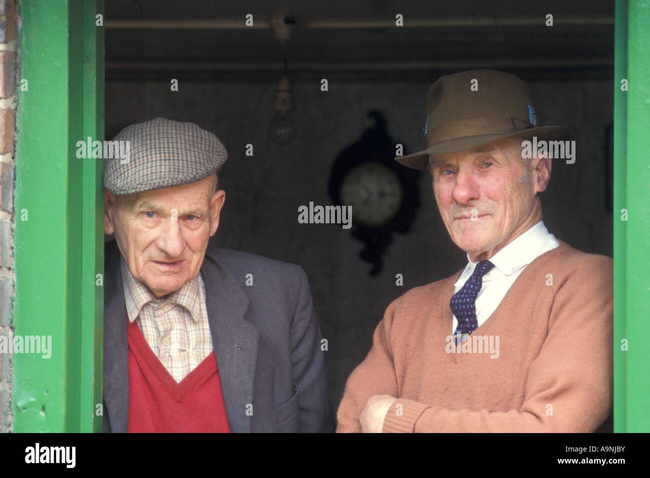 portrait two old english gentlemen standing in cottage doorway one in ...