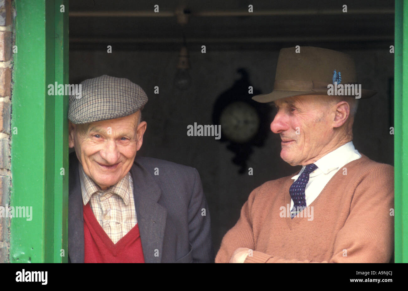 portrait two fine old englishmen standing in cottage doorway one in cap ...