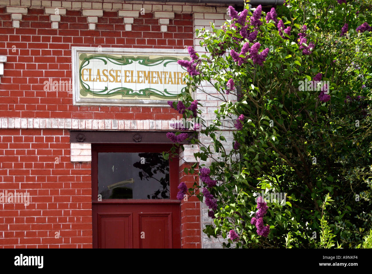 Tiled sign above door to old country school building Art Nouveau Stock ...