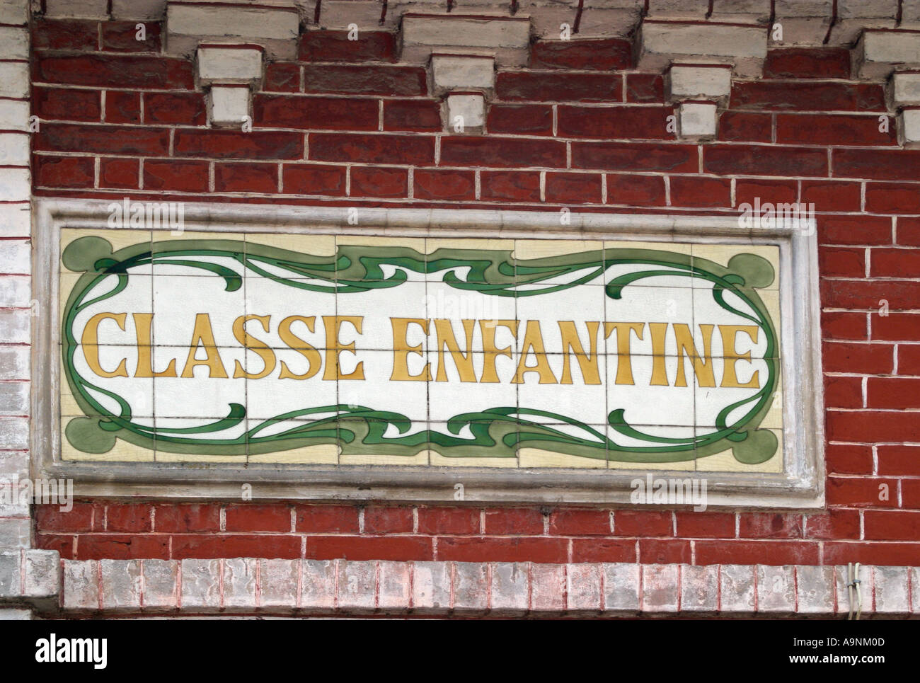 Tiled sign above door to old country school building Art Nouveau Stock ...