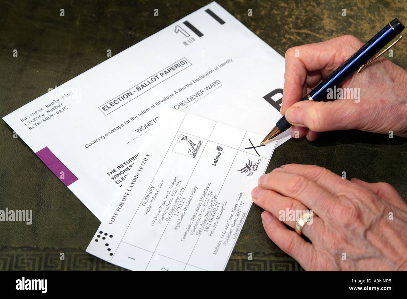 Completing a postal vote ballot paper. X cross marks the candidate ...