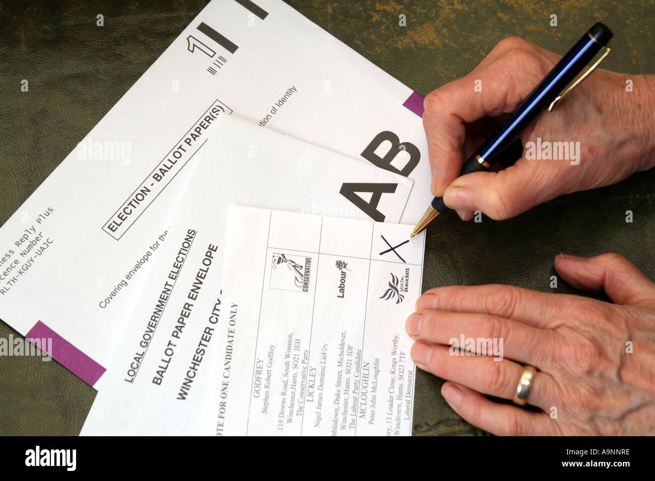Completing a postal vote ballot paper. X cross marks the candidate ...