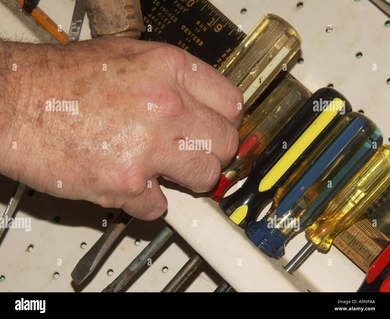 Hand reaching for a screwdriver Stock Photo - Alamy