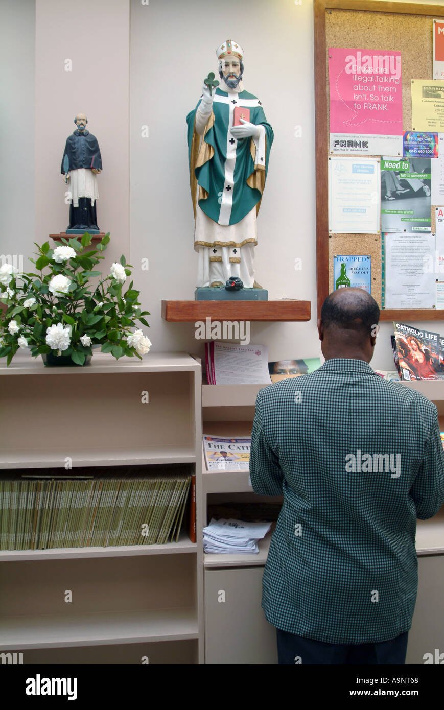 BLACK CATHOLIC MAN IN CATHOLIC CHURCH LONDON 2005 Stock Photo - Alamy